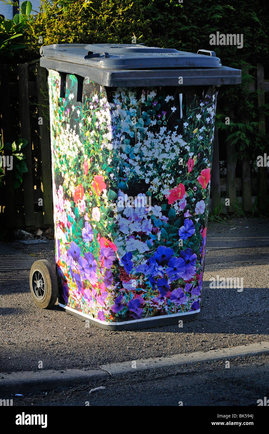 Hand decorated domestic rubbish 'wheelie bin' waiting outside house for ...