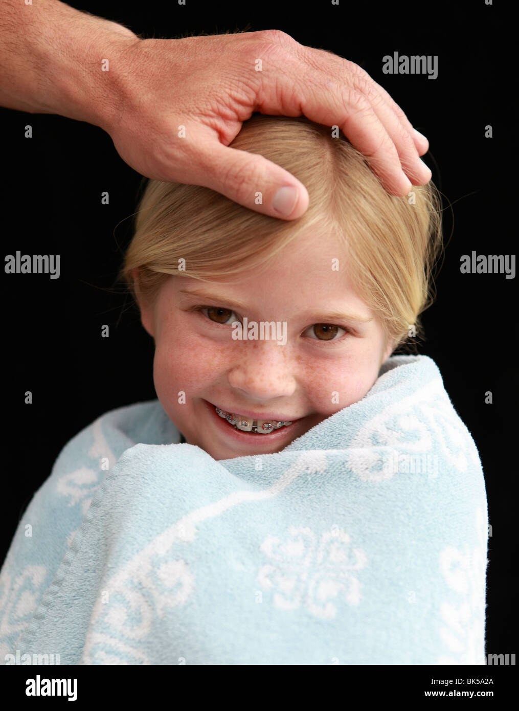 Fathers hand on daughters head Stock Photo - Alamy