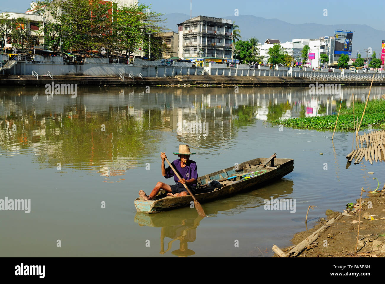 Old man paddling a canoe on Mae Ping River in Chiang Mai city, Thailand ...