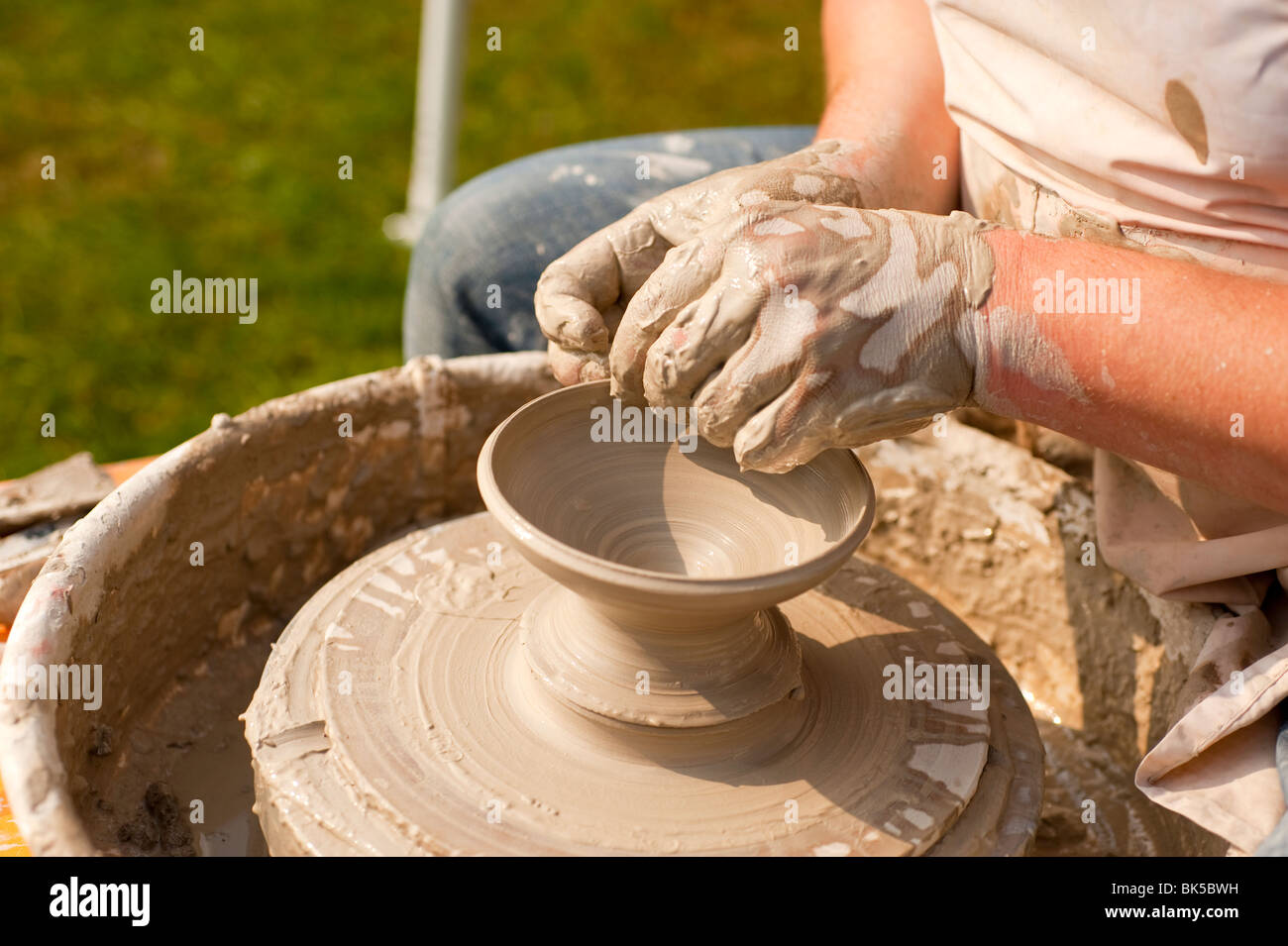 Potter forming pot from clay on potters wheel Stock Photo - Alamy