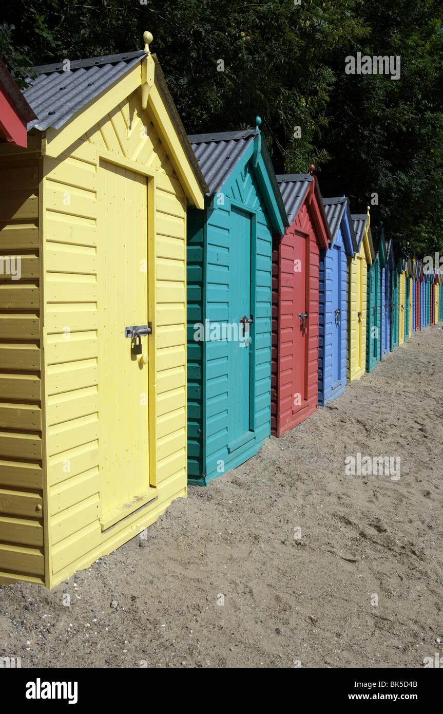 Coloured beach huts in a row Stock Photo - Alamy