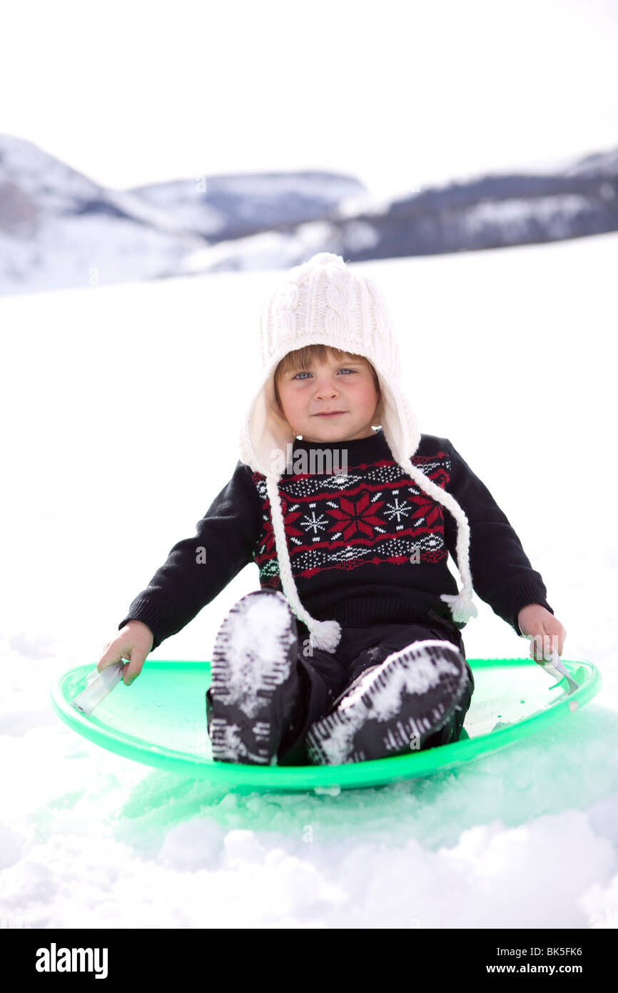 Young boy sled riding Stock Photo - Alamy