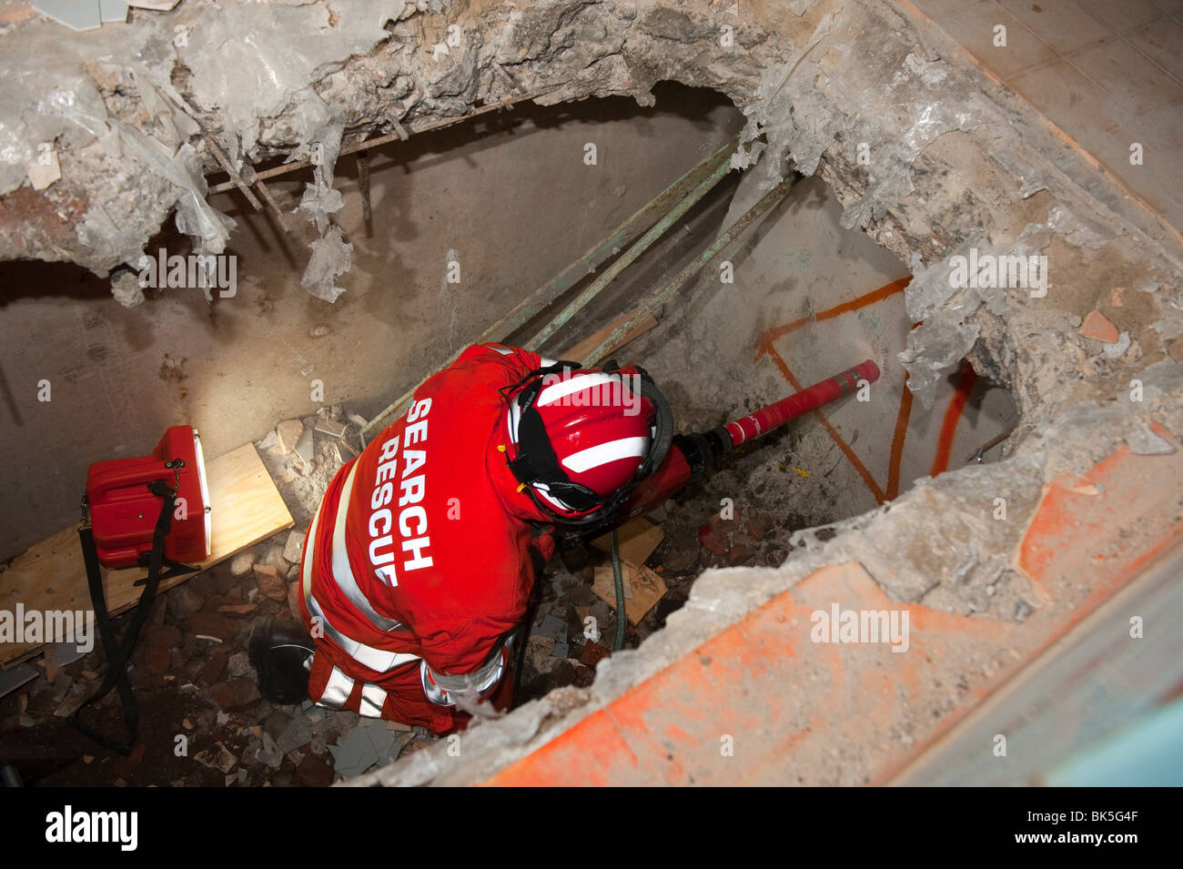 Fire Search & Rescue breaching and breaking through concrete wall Stock ...