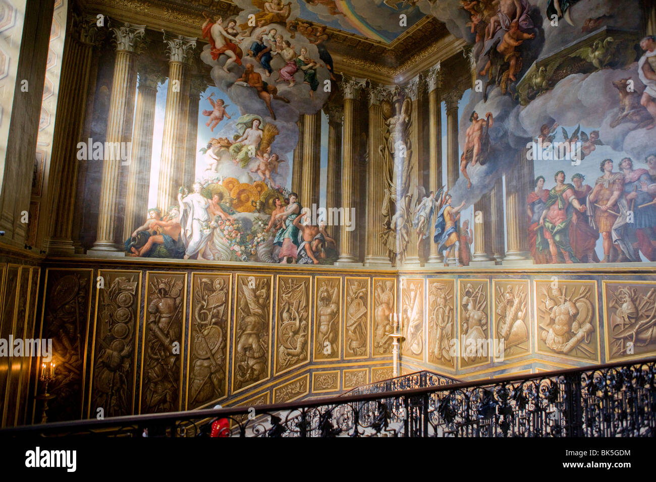 A stairway decorated with ornate paintings inside Hampton Court Palace ...