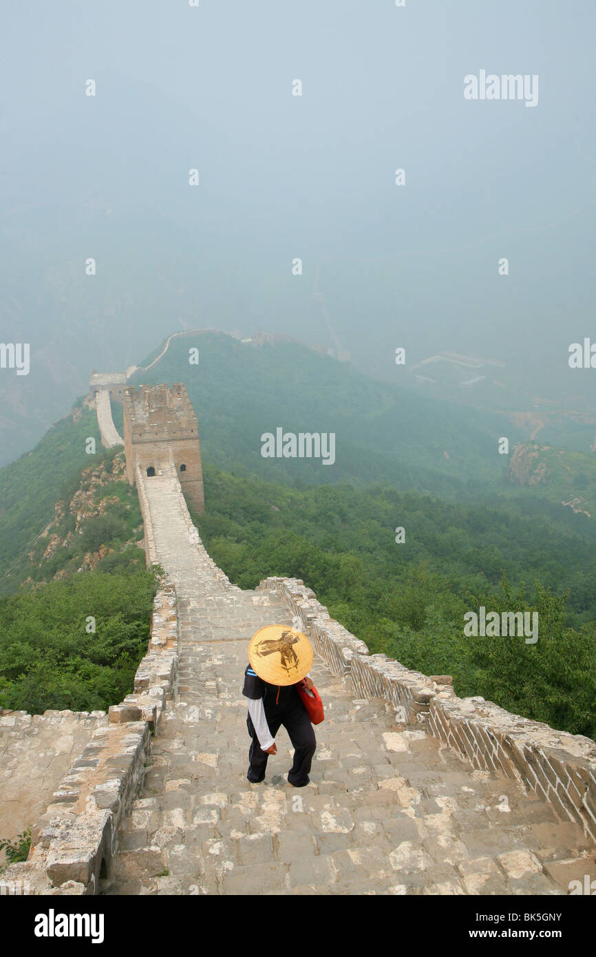 Tourist climbing up steps on a wall, Great Wall of China, Beijing ...