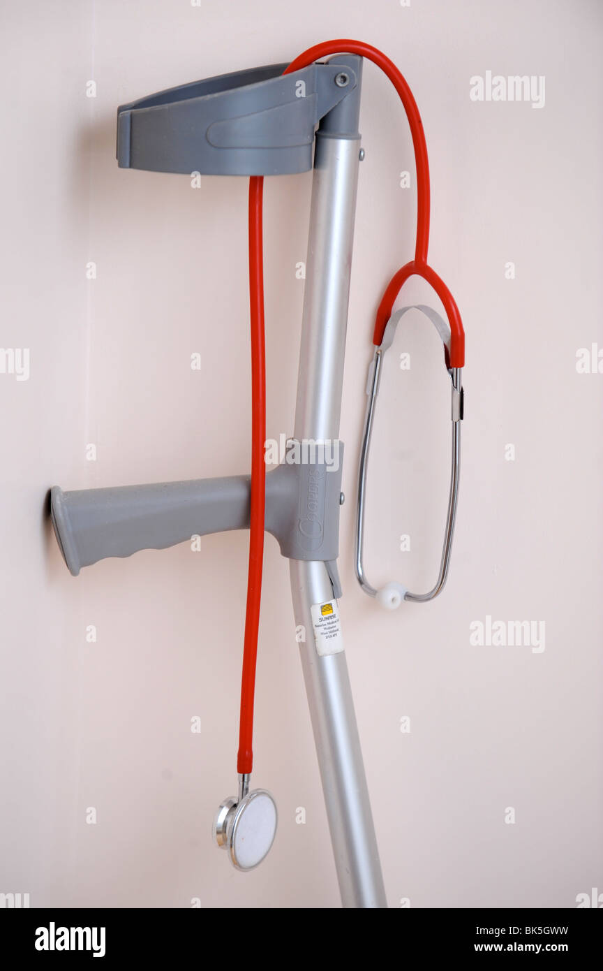 A hospital walking crutch and a doctor's stethoscope Stock Photo - Alamy