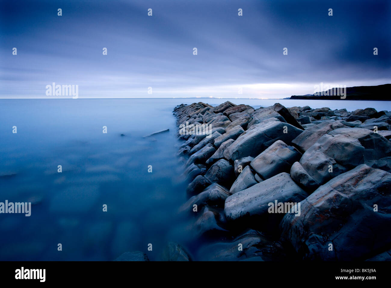 Stone jetty at twilight, Kimmeridge Bay, Purbeck District, Dorset ...