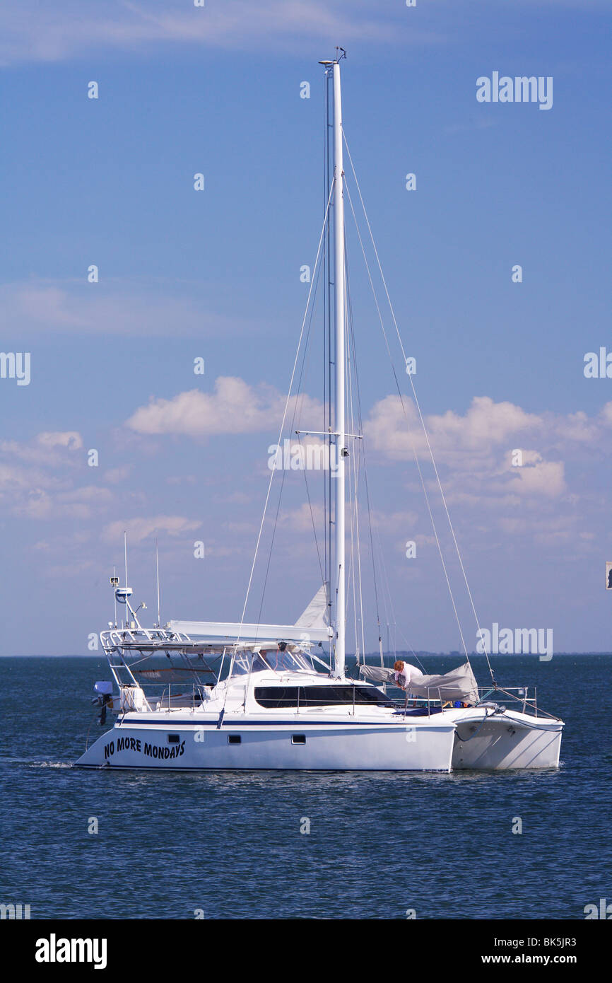 CREW SAILING LARGE CATAMARAN IN OPEN WATER Stock Photo - Alamy