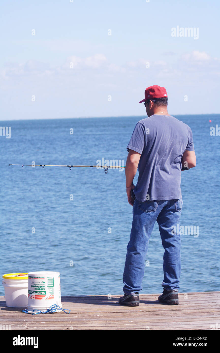 MAN STANDING ON PIER FISHING Stock Photo - Alamy
