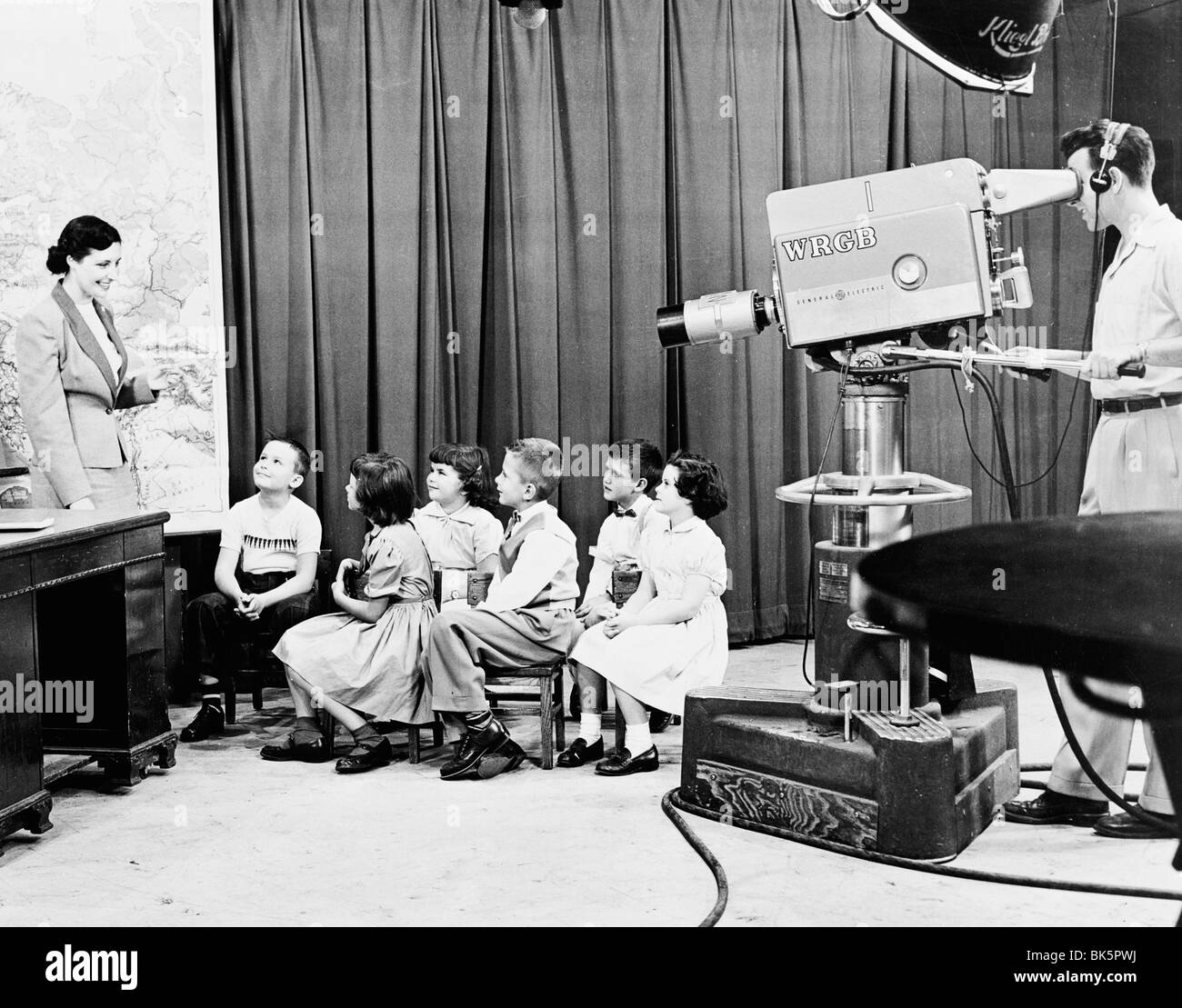 Young woman with group of children in recording studio Stock Photo - Alamy