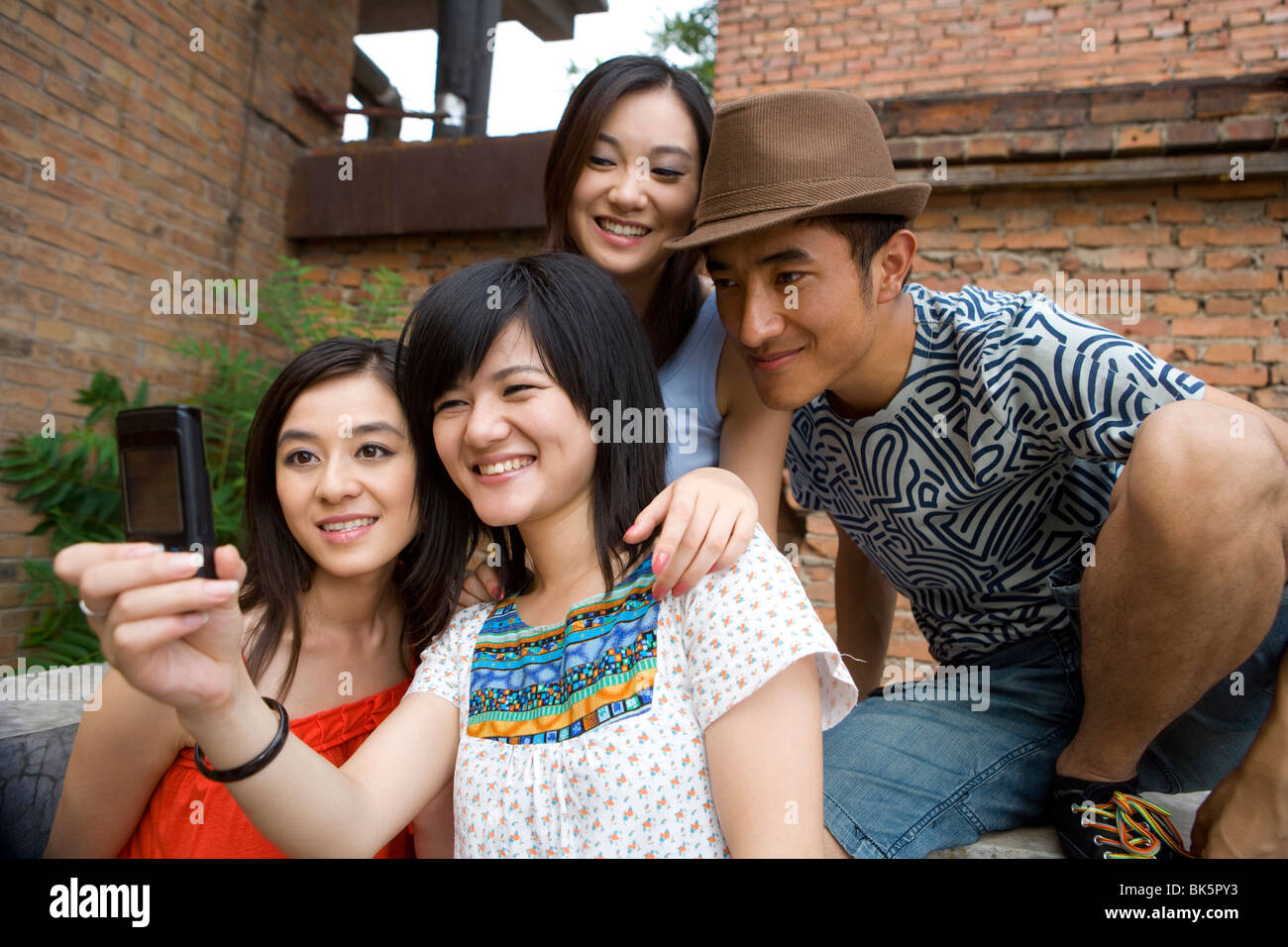 Friends taking photos with mobile phone Stock Photo - Alamy