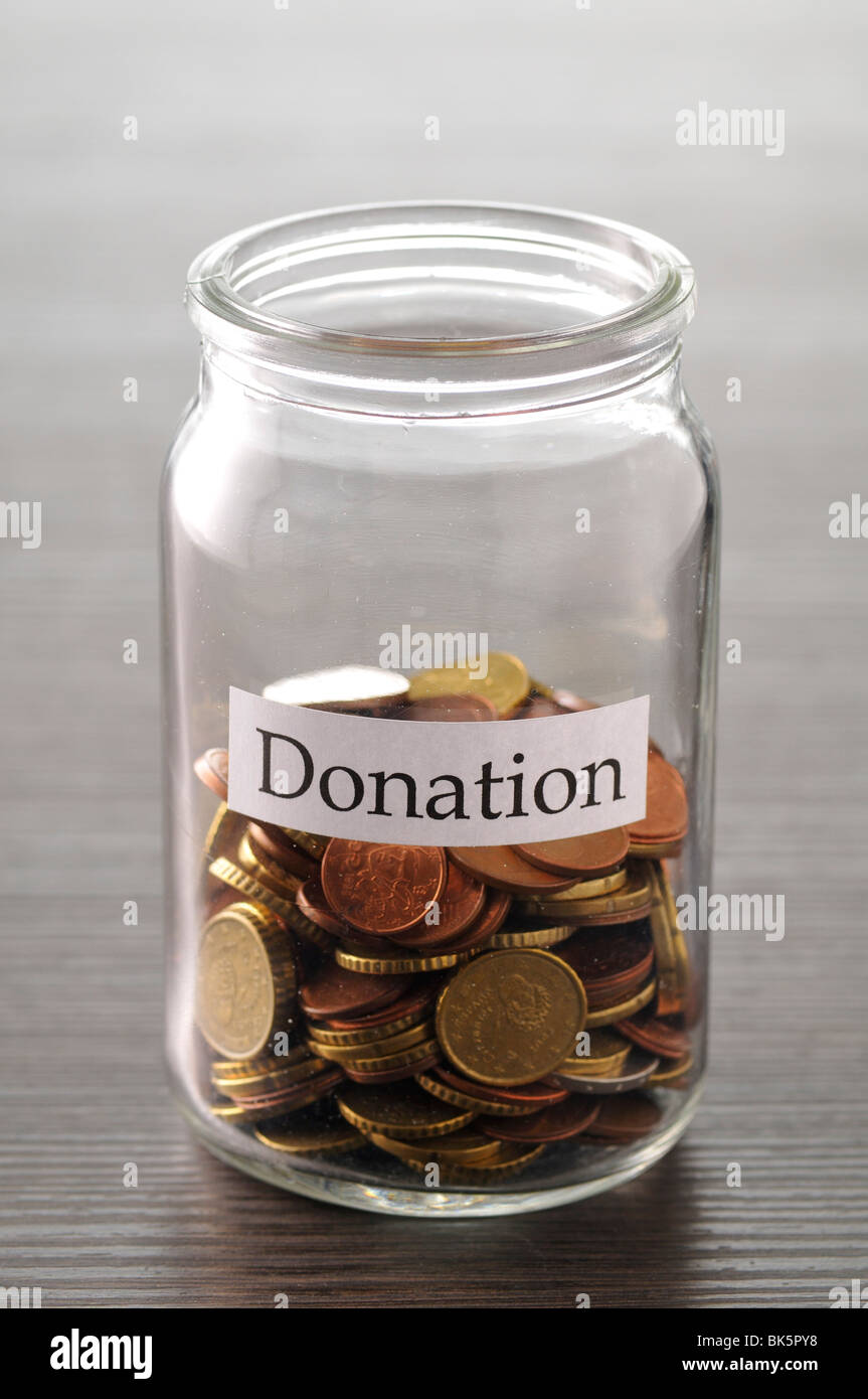 Coins in Donation Jar Stock Photo - Alamy