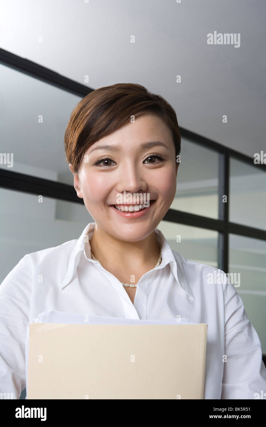 Office worker holding a folder Stock Photo - Alamy