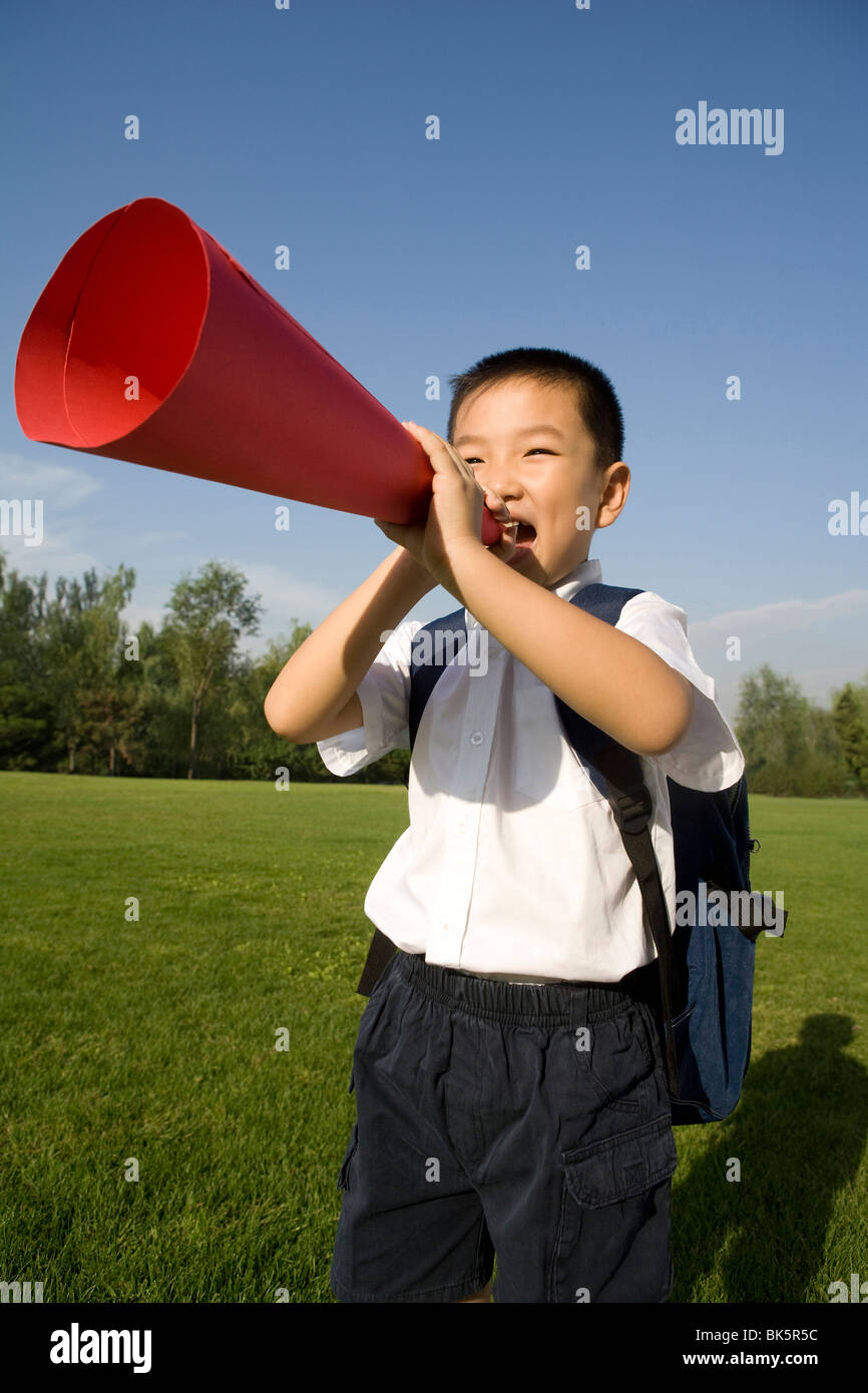 Boy with a red megaphone Stock Photo - Alamy