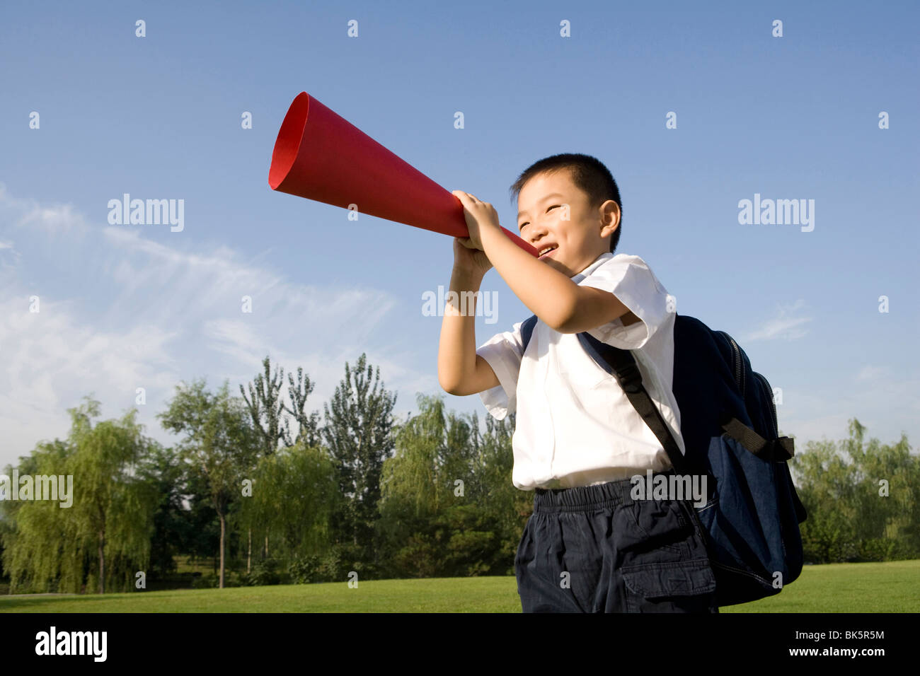 Boy with a red megaphone Stock Photo - Alamy