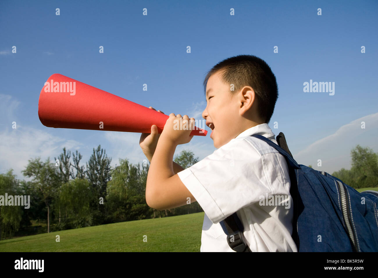 Boy with a red megaphone Stock Photo - Alamy