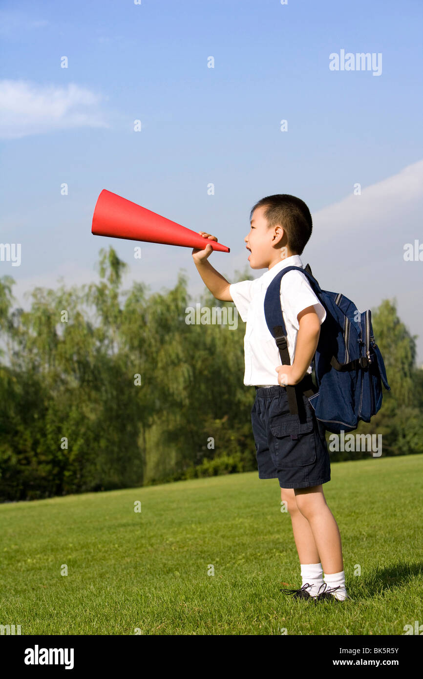 Boy with a red megaphone Stock Photo - Alamy