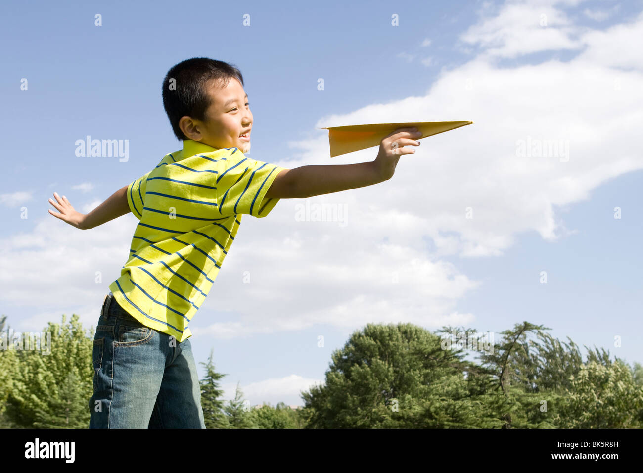 Boy playing with a paper airplane Stock Photo - Alamy