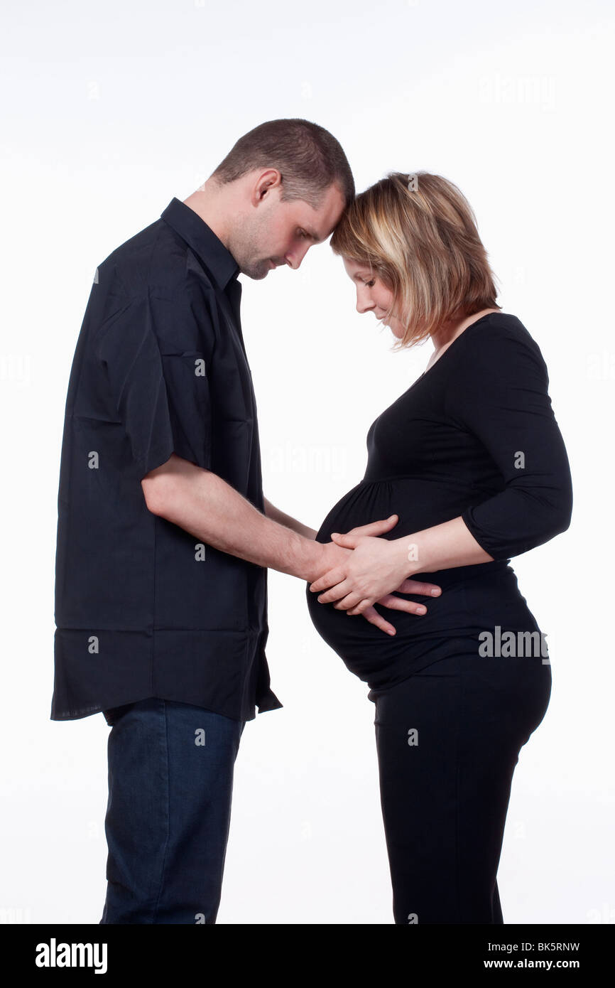 happy expecting couple holding each other - isolated on white Stock ...