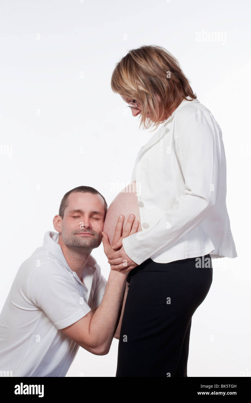 happy expecting couple holding each other - isolated on white Stock ...