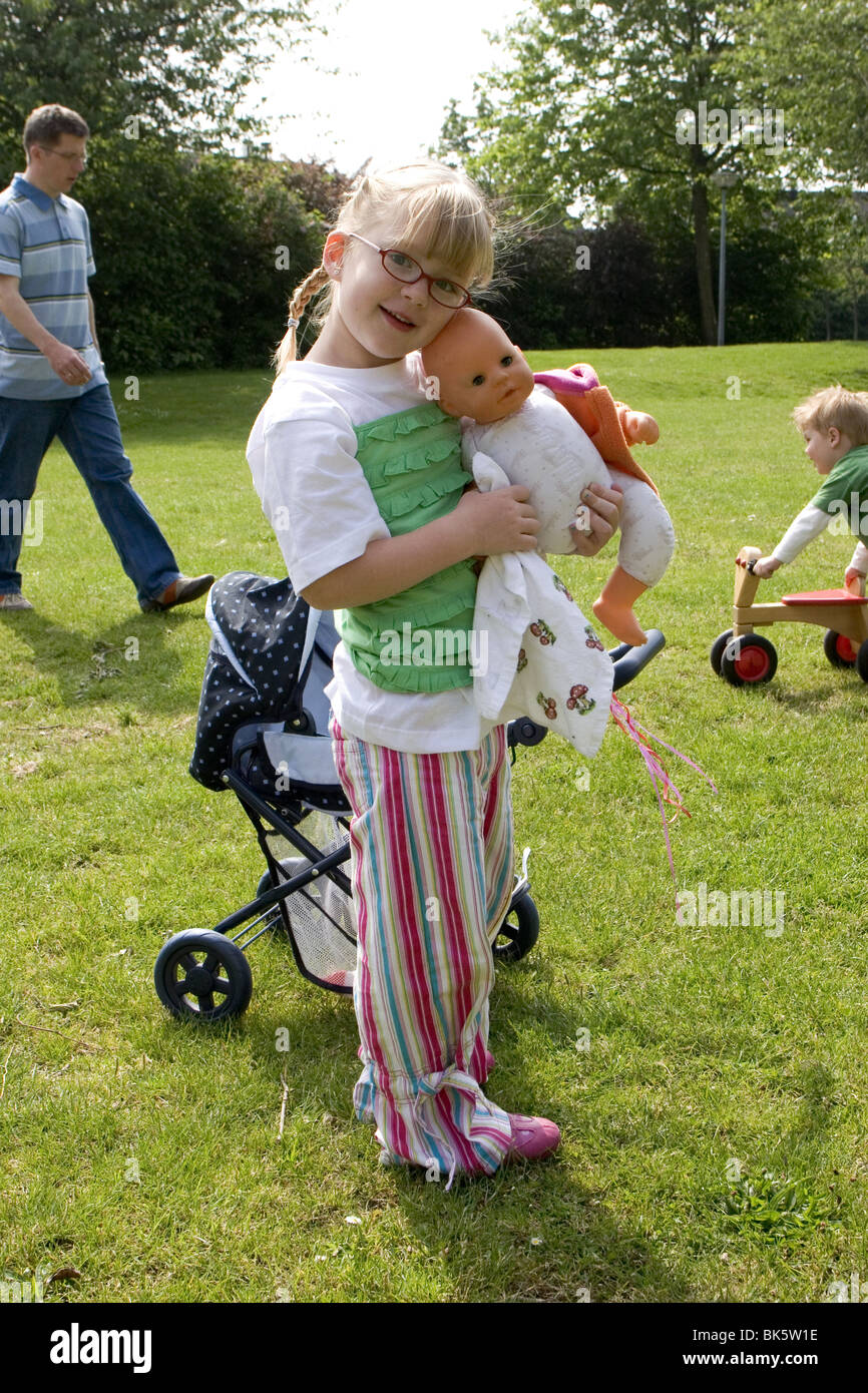 Male kids playing with dolls hi-res stock photography and images - Alamy