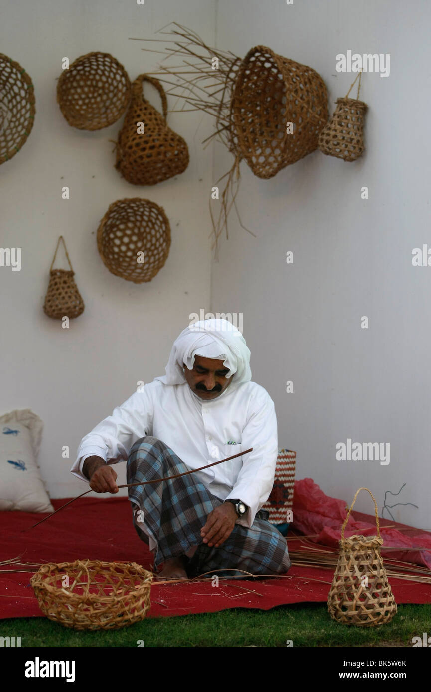 Arabian basket weaver sitting on the ground and weaving a basket Stock ...