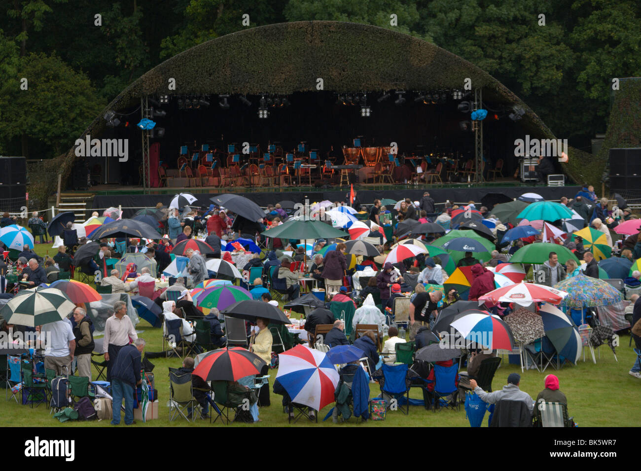 waiting audience in rain for twinwoods prom in park bedfordshire ...