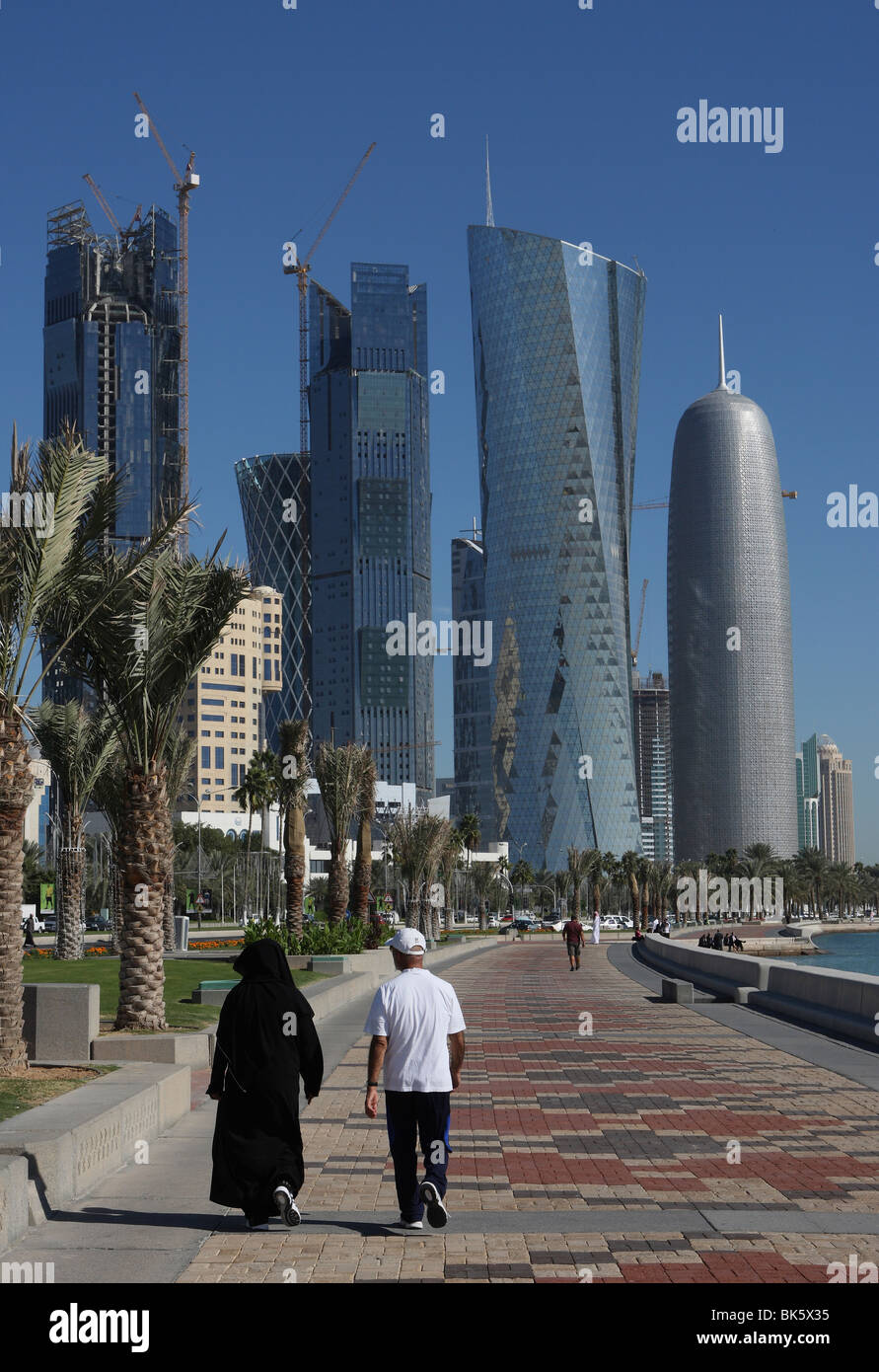 Arabic couple walking along the Corniche in Doha,Qatar Stock Photo - Alamy