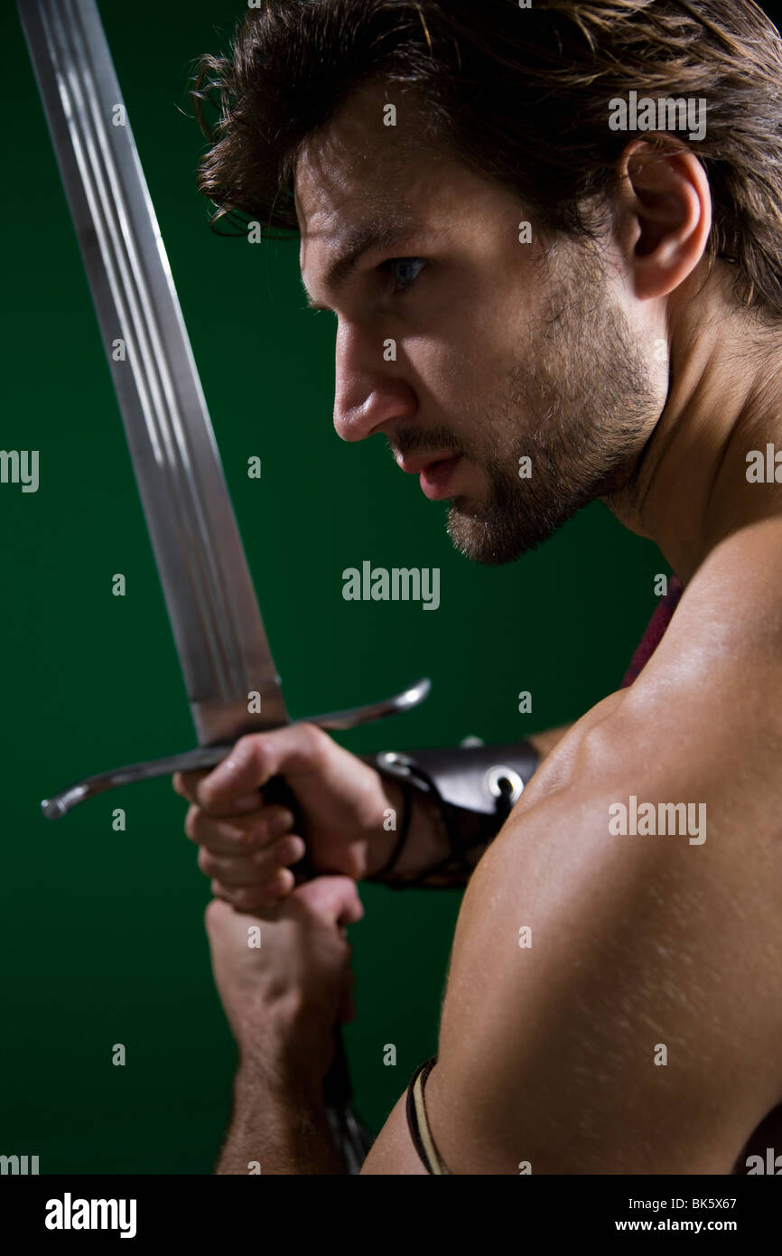 Man holding sword hi-res stock photography and images - Alamy