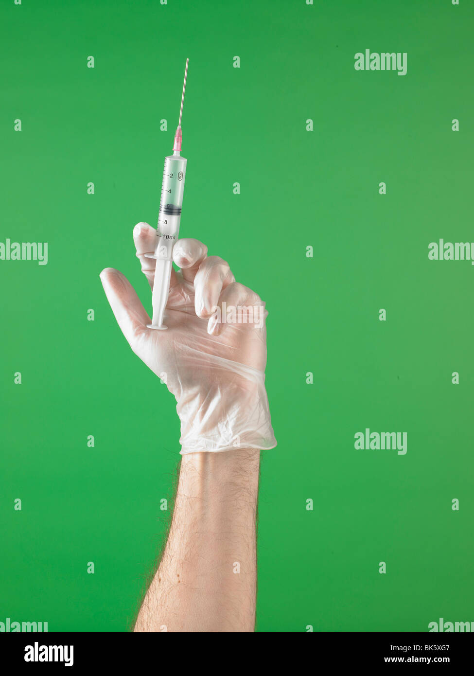 Medical gloved hand with syringe and needles Stock Photo - Alamy