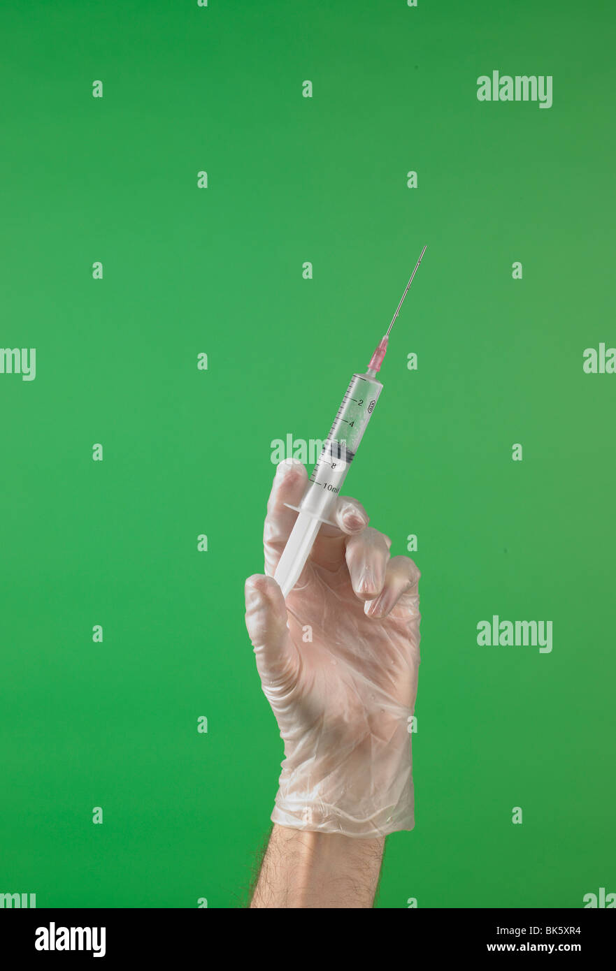Medical gloved hand with syringe Stock Photo - Alamy