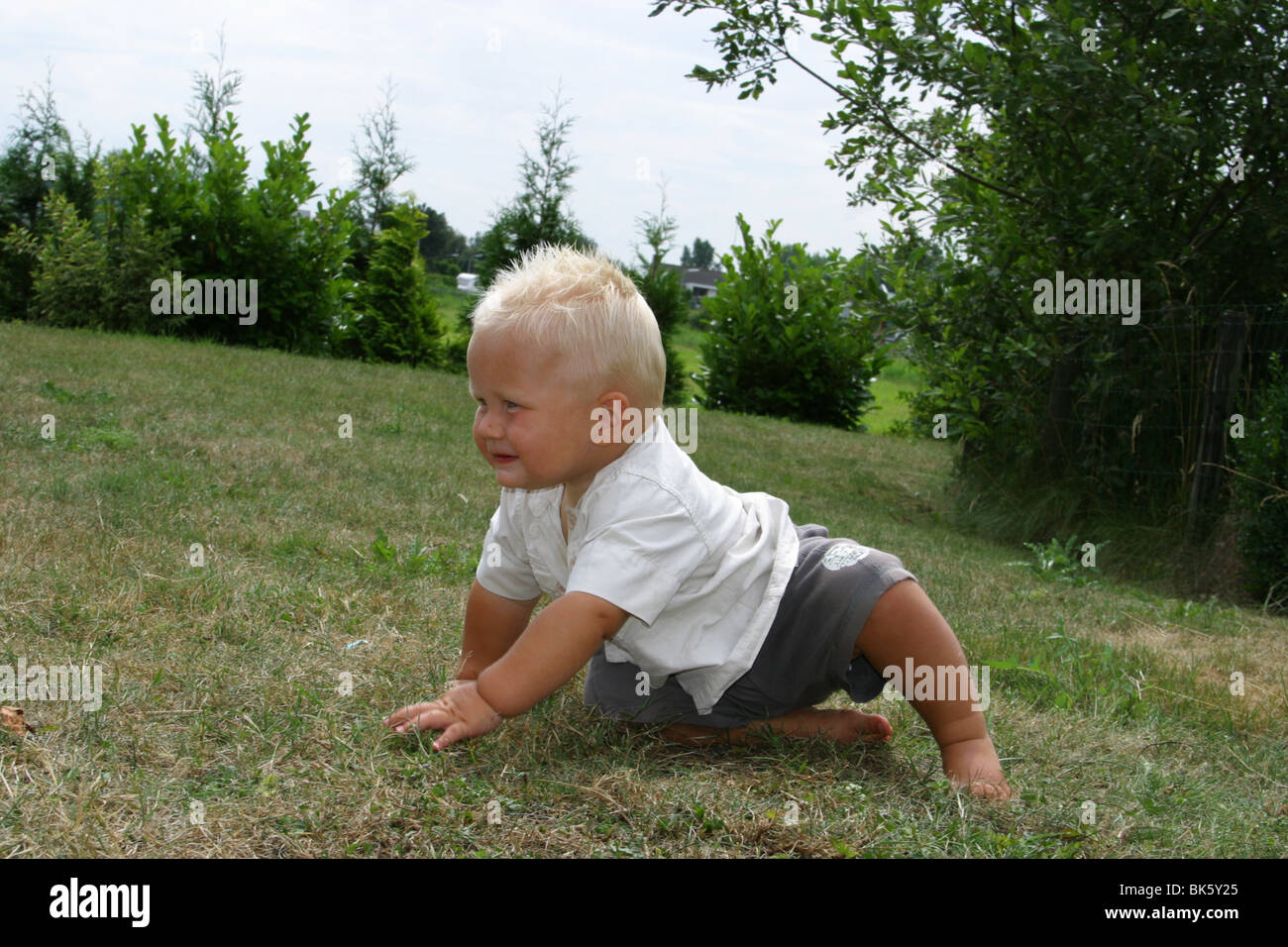 Baby boy exploring outside Stock Photo - Alamy