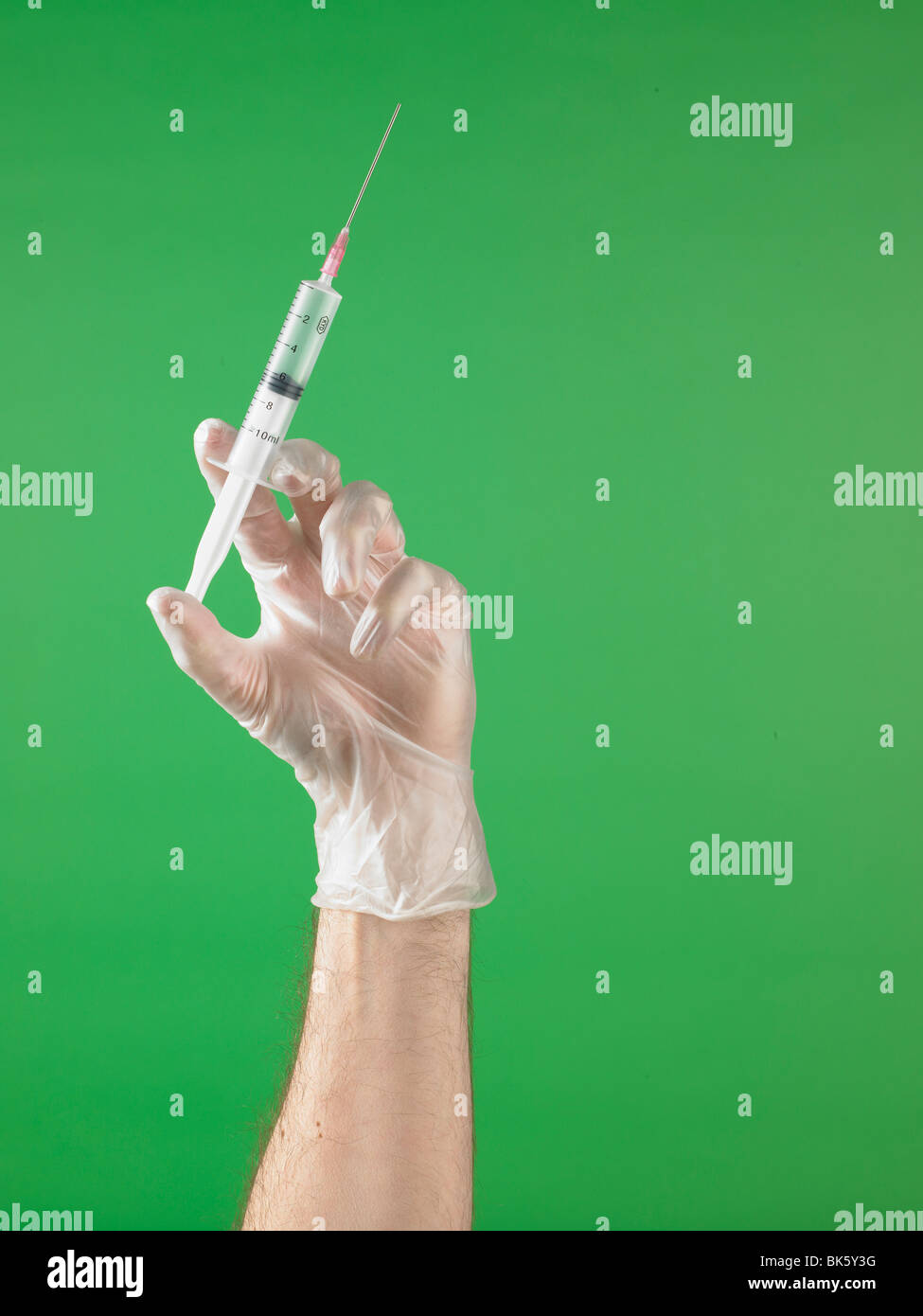 liquid filled syringe and medical gloved hand Stock Photo - Alamy