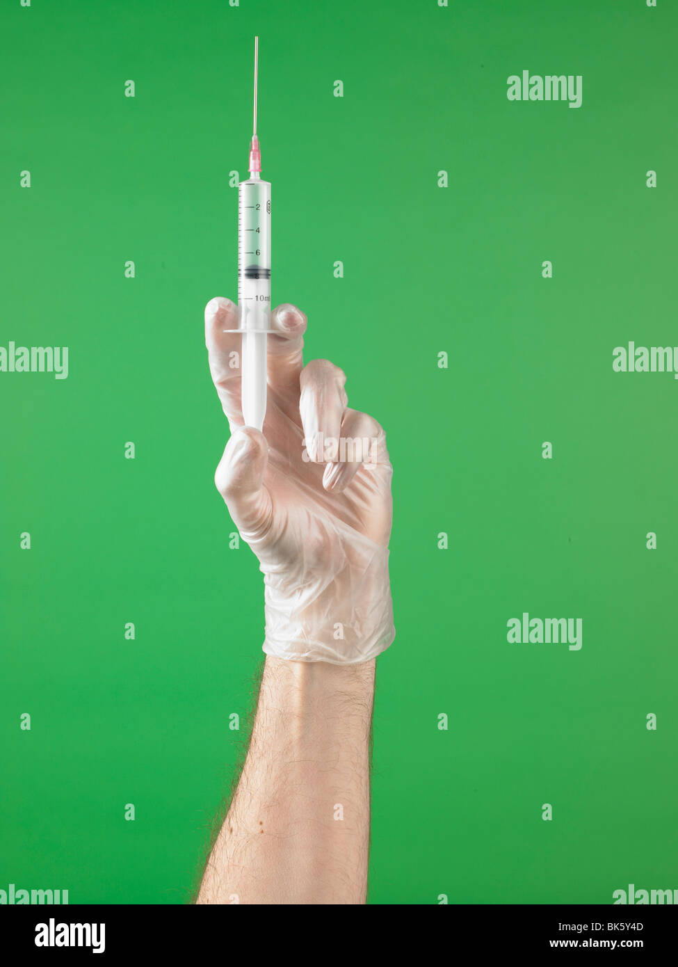 Medical gloved hand with syringe and needles and mans arm Stock Photo ...