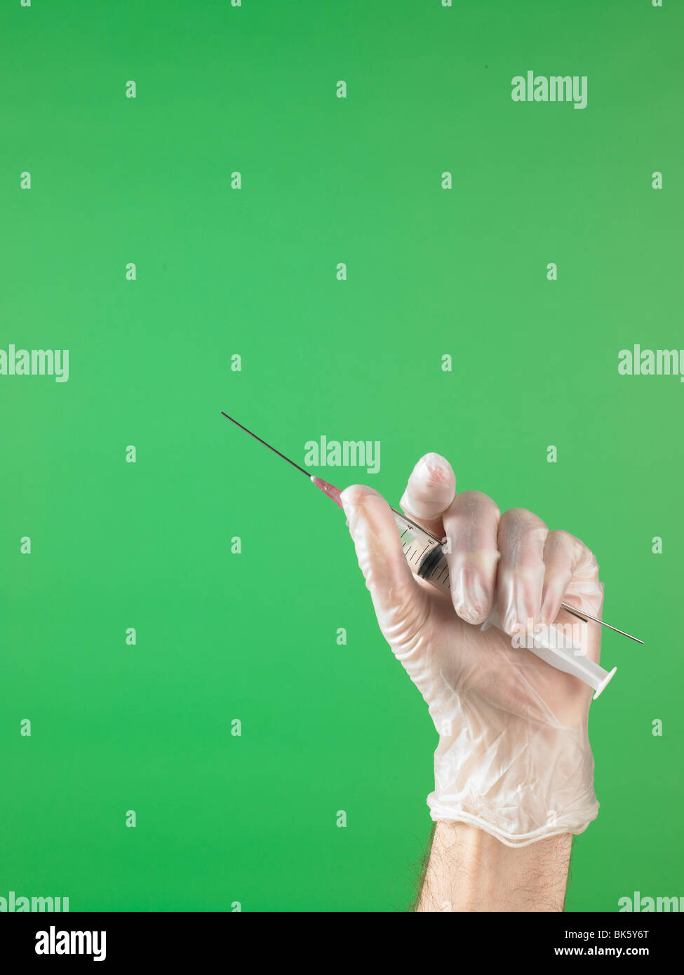 Medical gloved hand with syringe and needles Stock Photo - Alamy