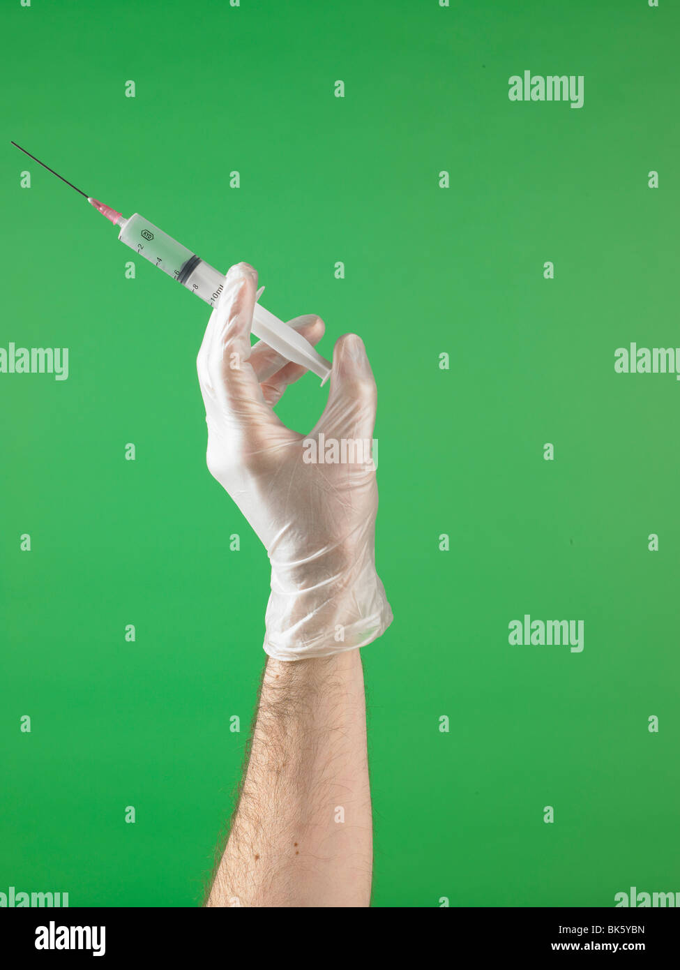 Medical gloved hand with syringe and needles Stock Photo - Alamy