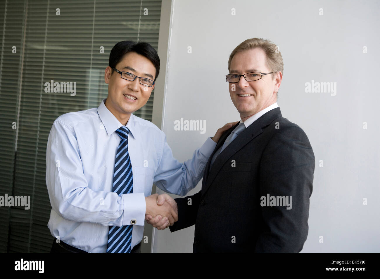 Businessmen shaking hands Stock Photo - Alamy