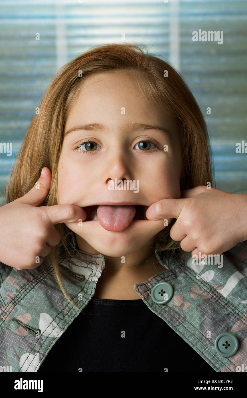 Close-up of a girl pulling her face Stock Photo - Alamy