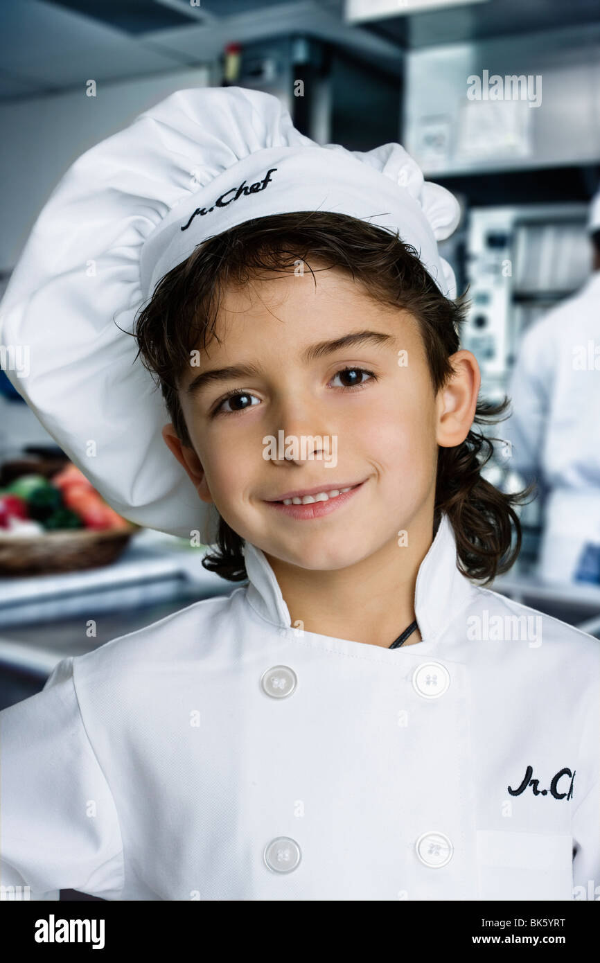 Boy in chef's whites in the kitchen Stock Photo - Alamy