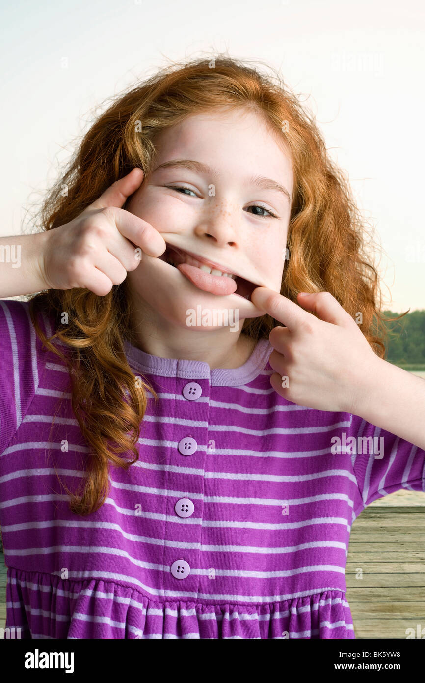 Close-up of a girl pulling her face Stock Photo - Alamy