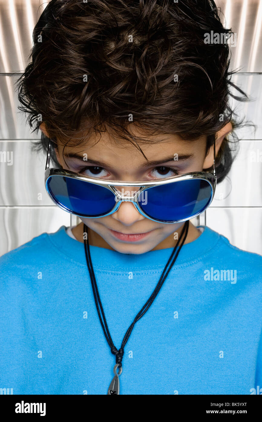 Boy looking over sunglasses Stock Photo - Alamy