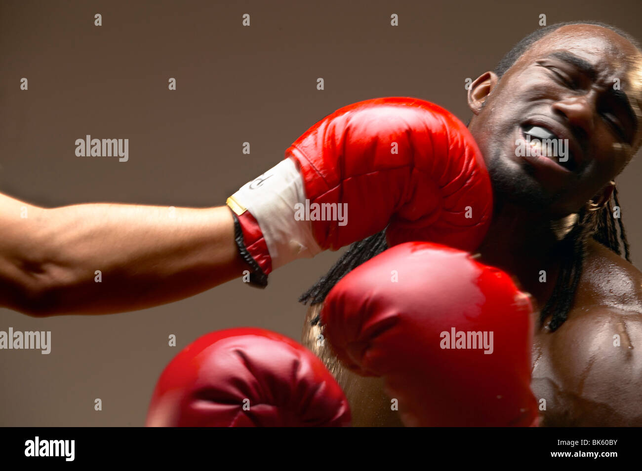 Boxer hitting a right hook to his competitor Stock Photo - Alamy
