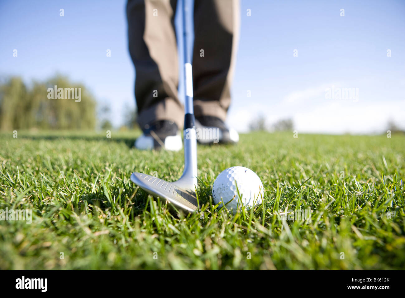 Golfer teeing off Stock Photo - Alamy