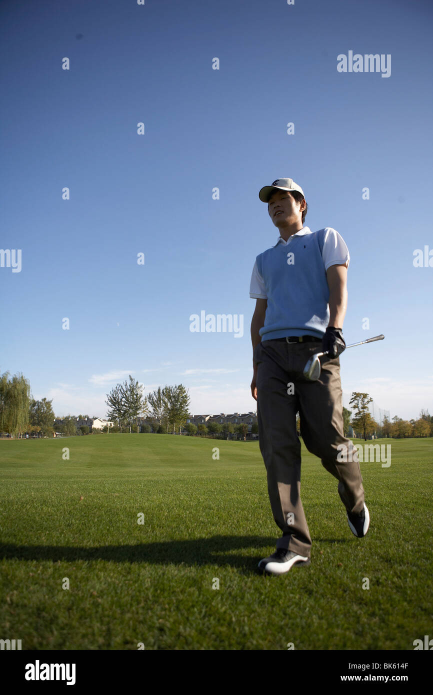 Man walking on golf course Stock Photo - Alamy