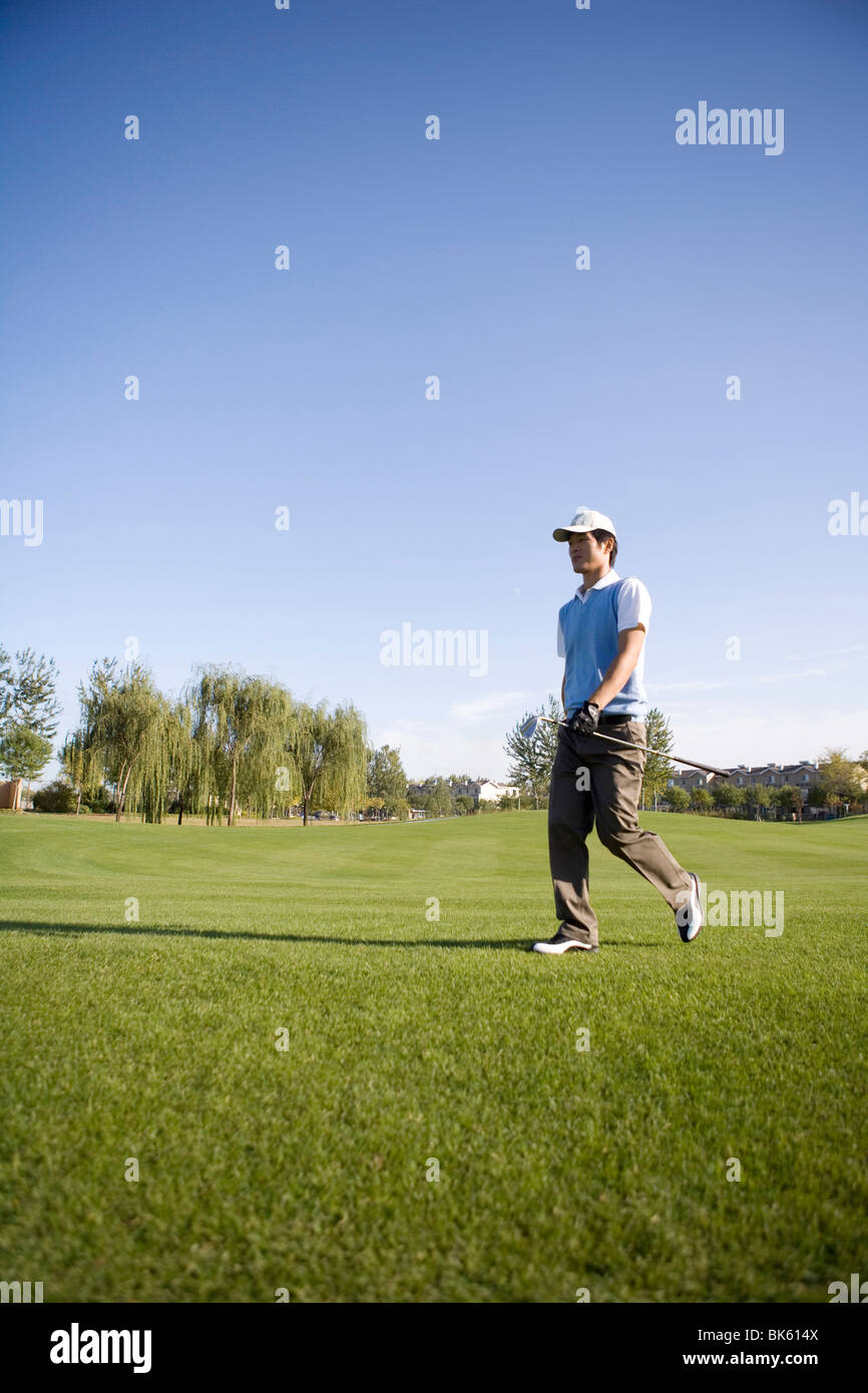 Man walking on golf course Stock Photo - Alamy