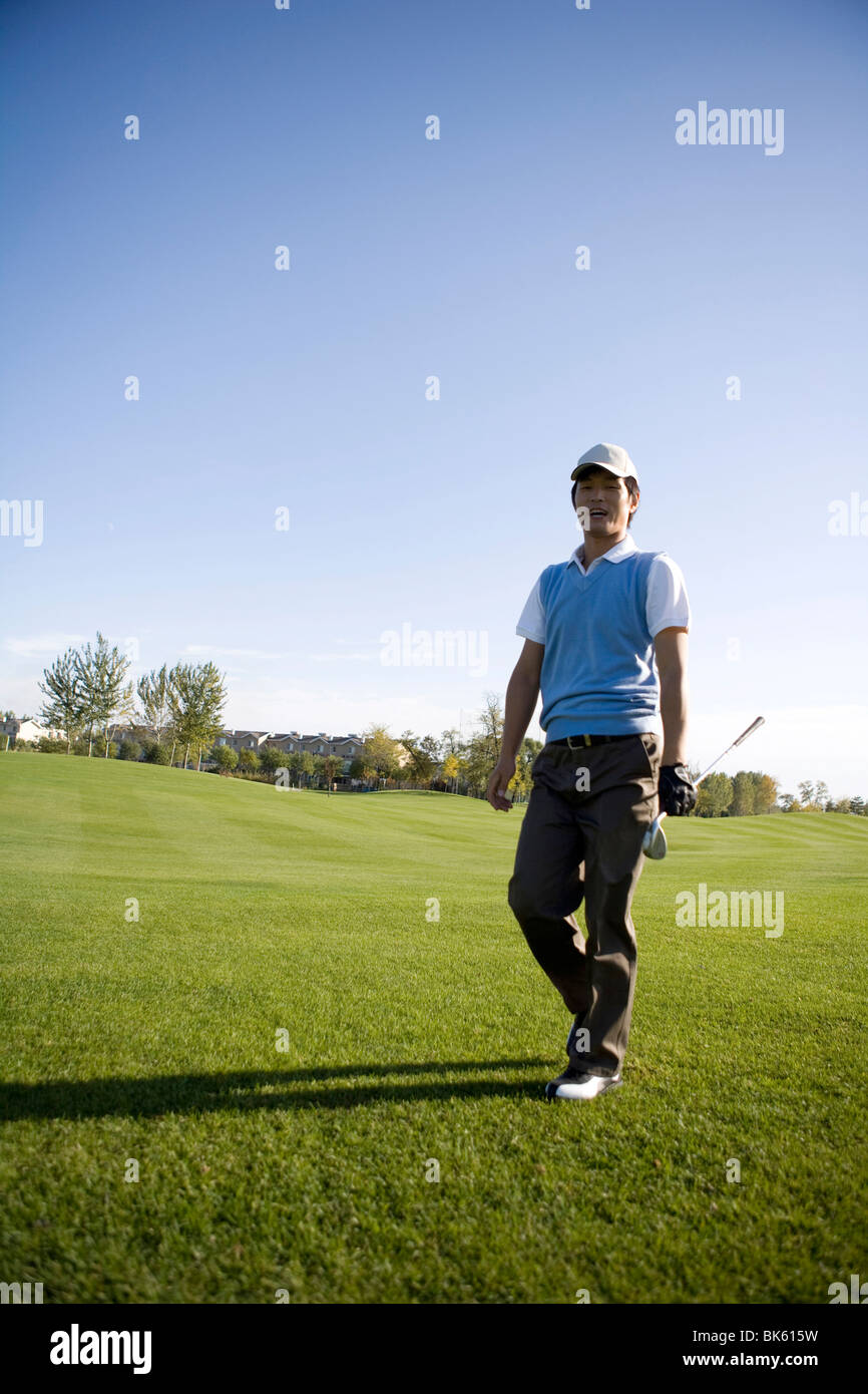 Man walking on golf course Stock Photo - Alamy