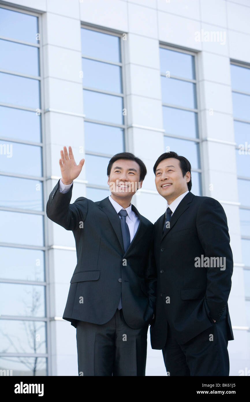 Standing gesturing communication leadership building exterior hi-res ...