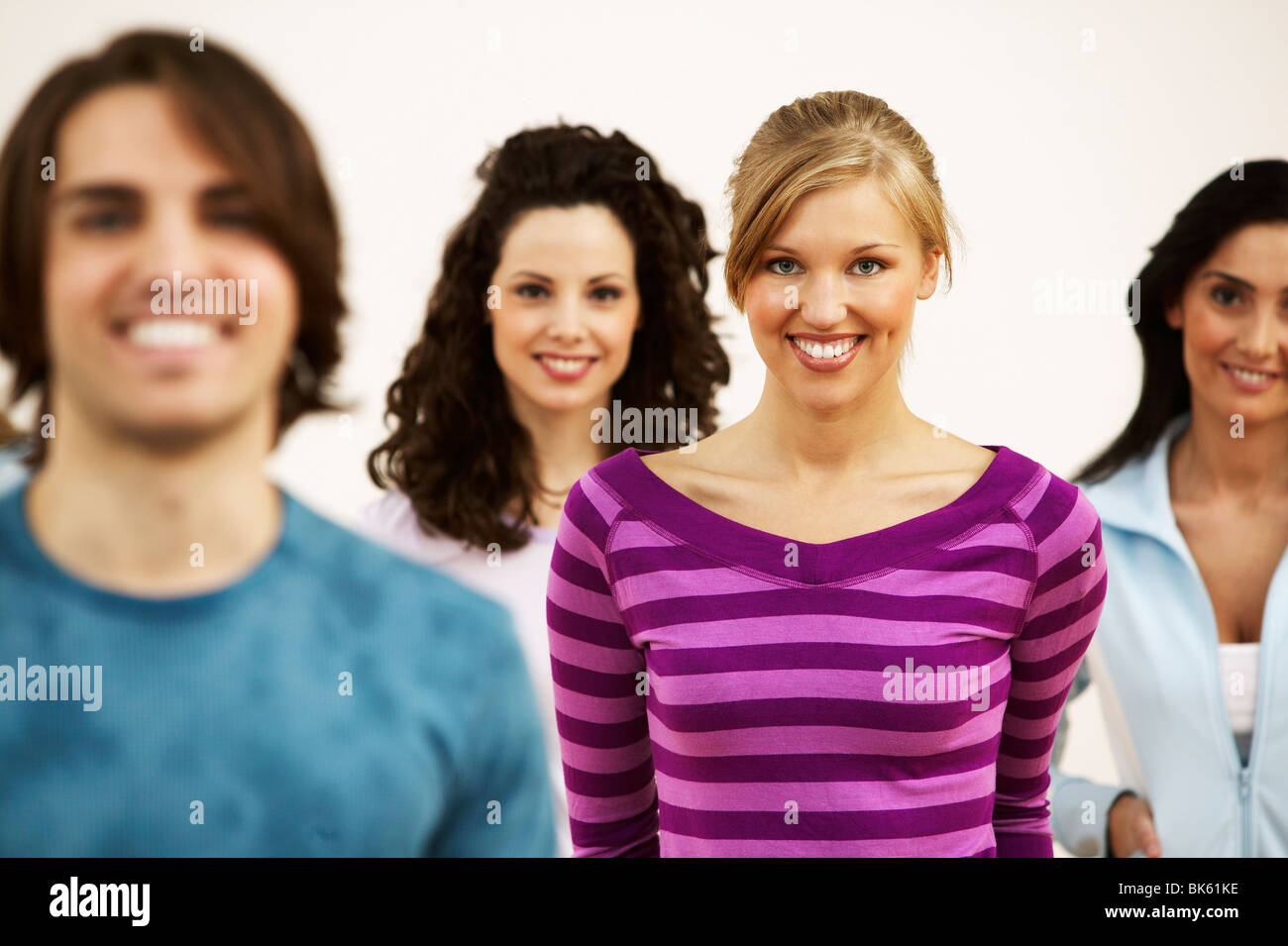Portrait of a young woman smiling with her friends Stock Photo - Alamy