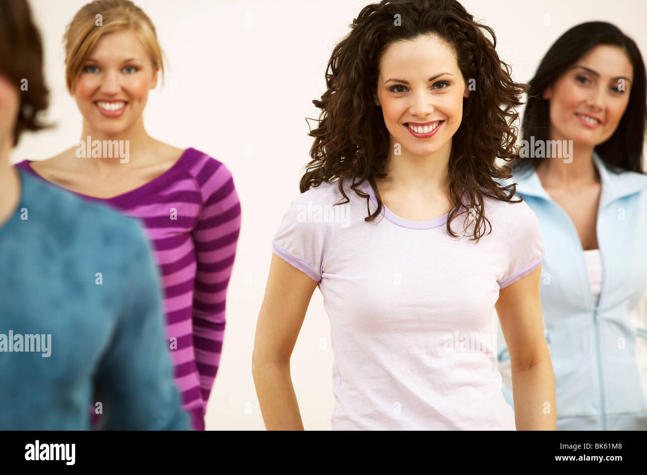Portrait of a young woman smiling with her friends Stock Photo - Alamy