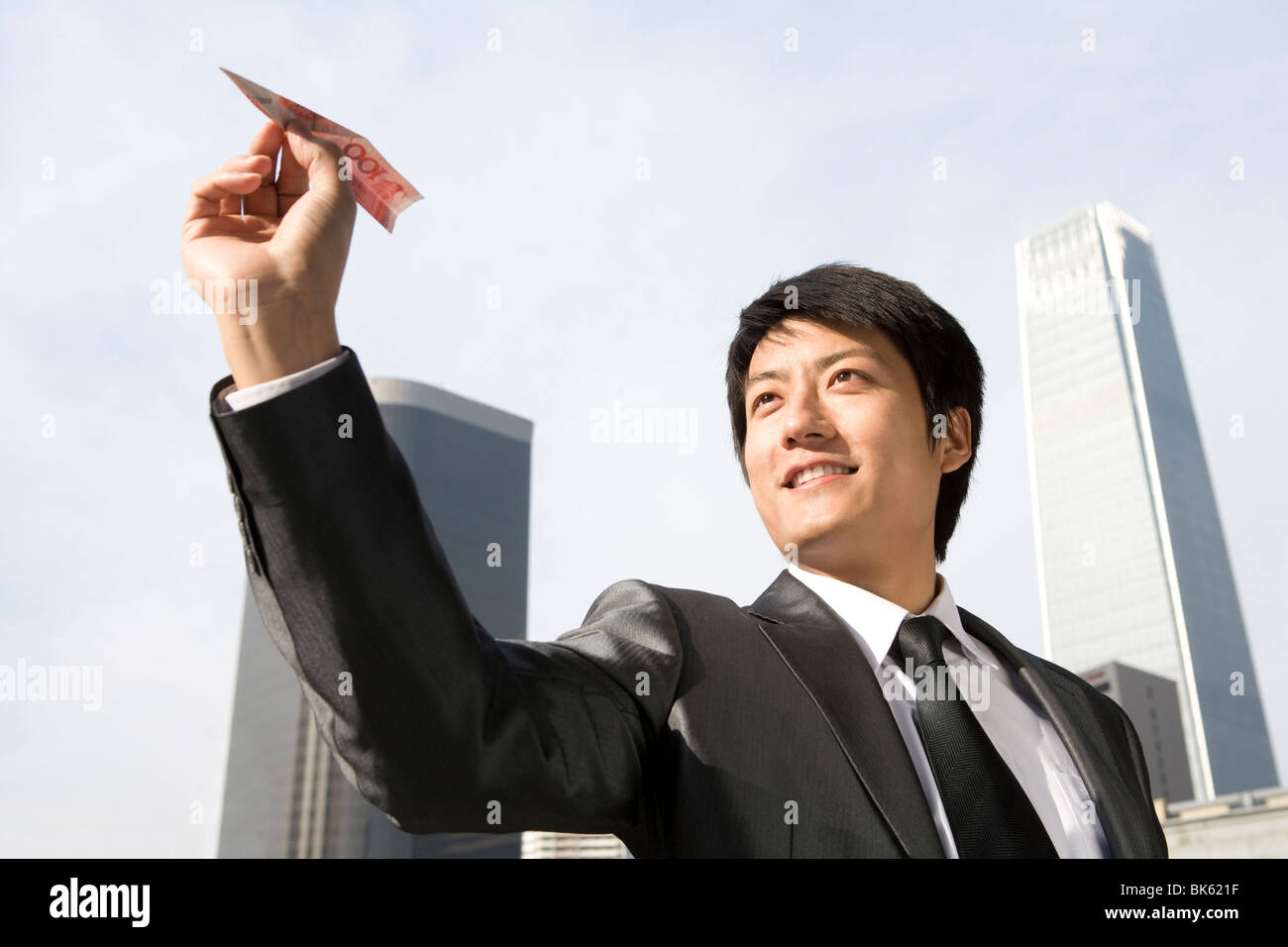 Businessman Flying RMB Paper Airplane Stock Photo - Alamy